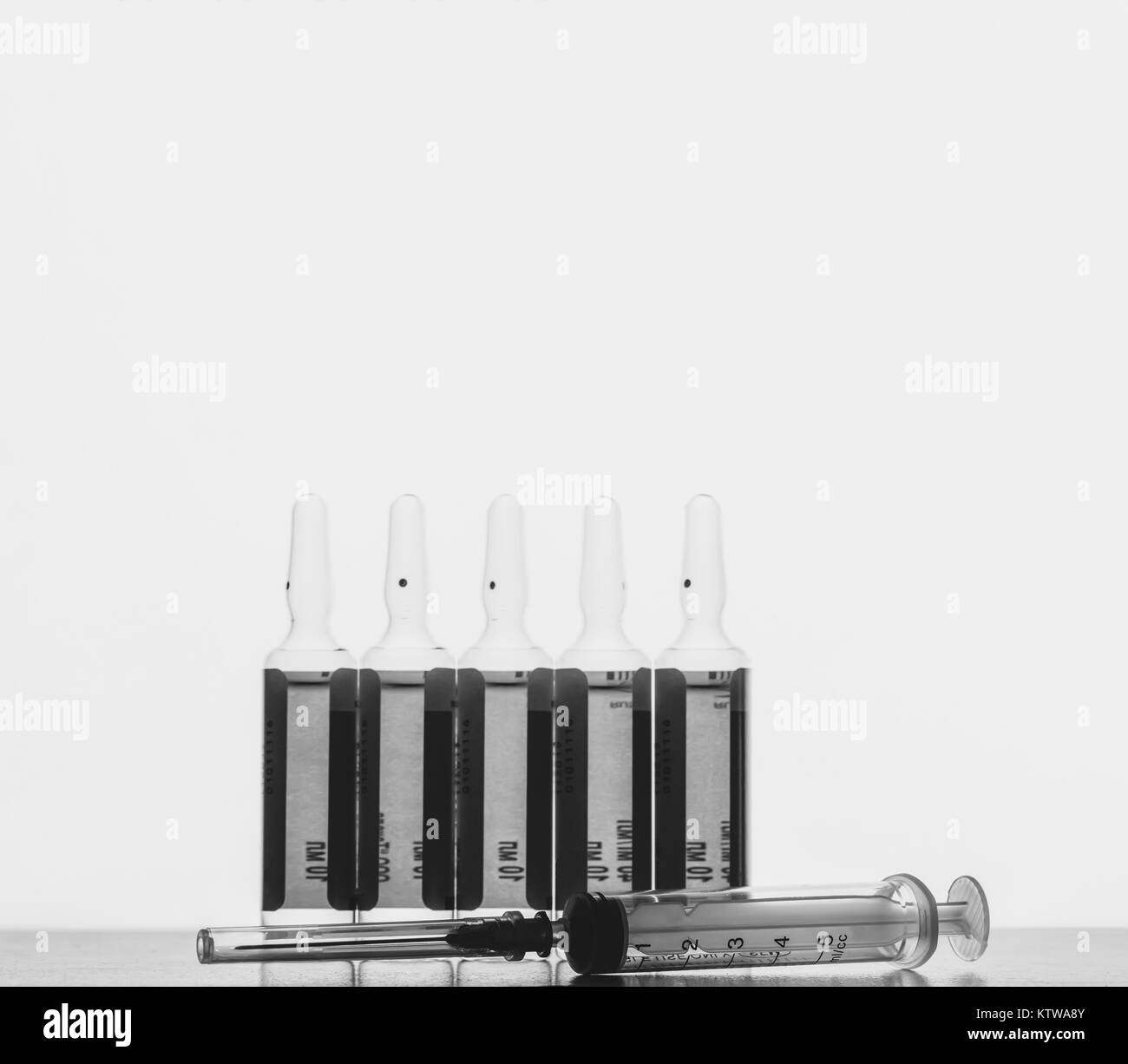 the ampoules with solution for injections and disposable syringe on ...