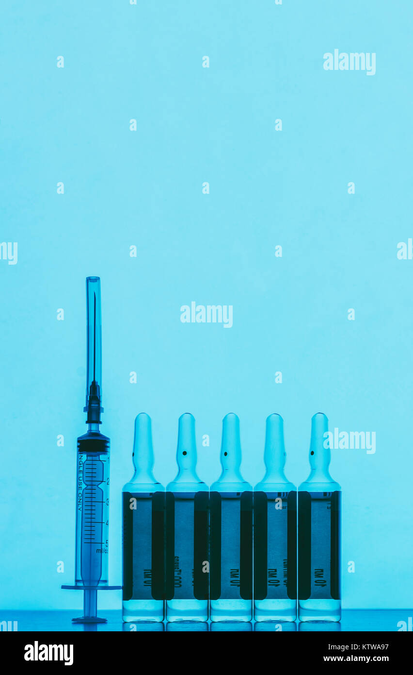 a disposable syringe and ampoules with a solution for injection on a ...