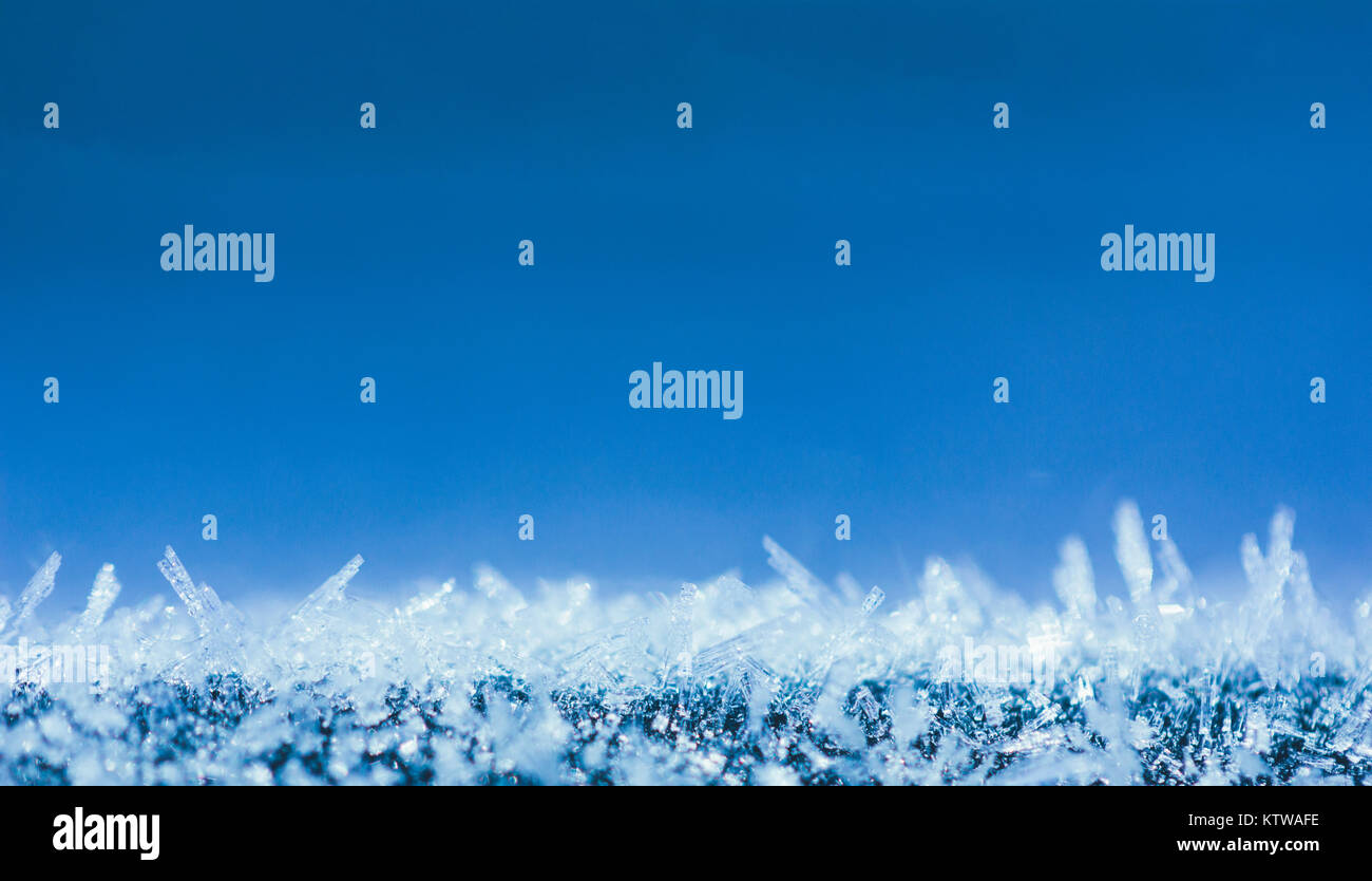 winter background with glittering ice crystals with copy space, macro ...