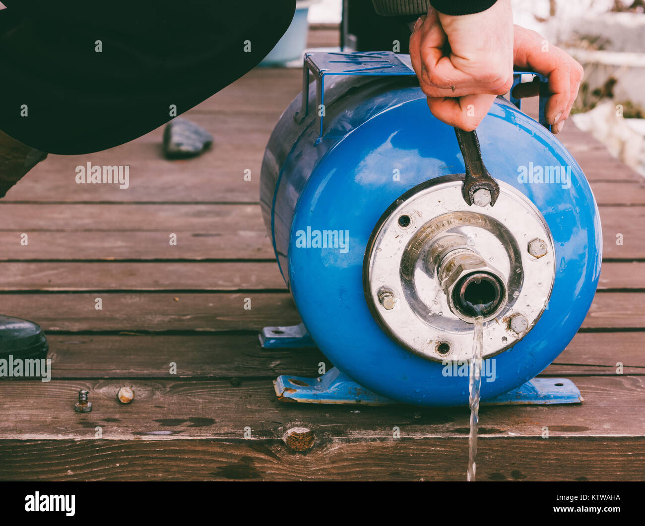 locksmith plumber repairing the water system expansion tank Stock Photo ...