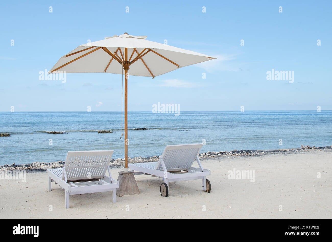 Tropical beach with sunbeds and umbrella in the summertime. Stock image ...
