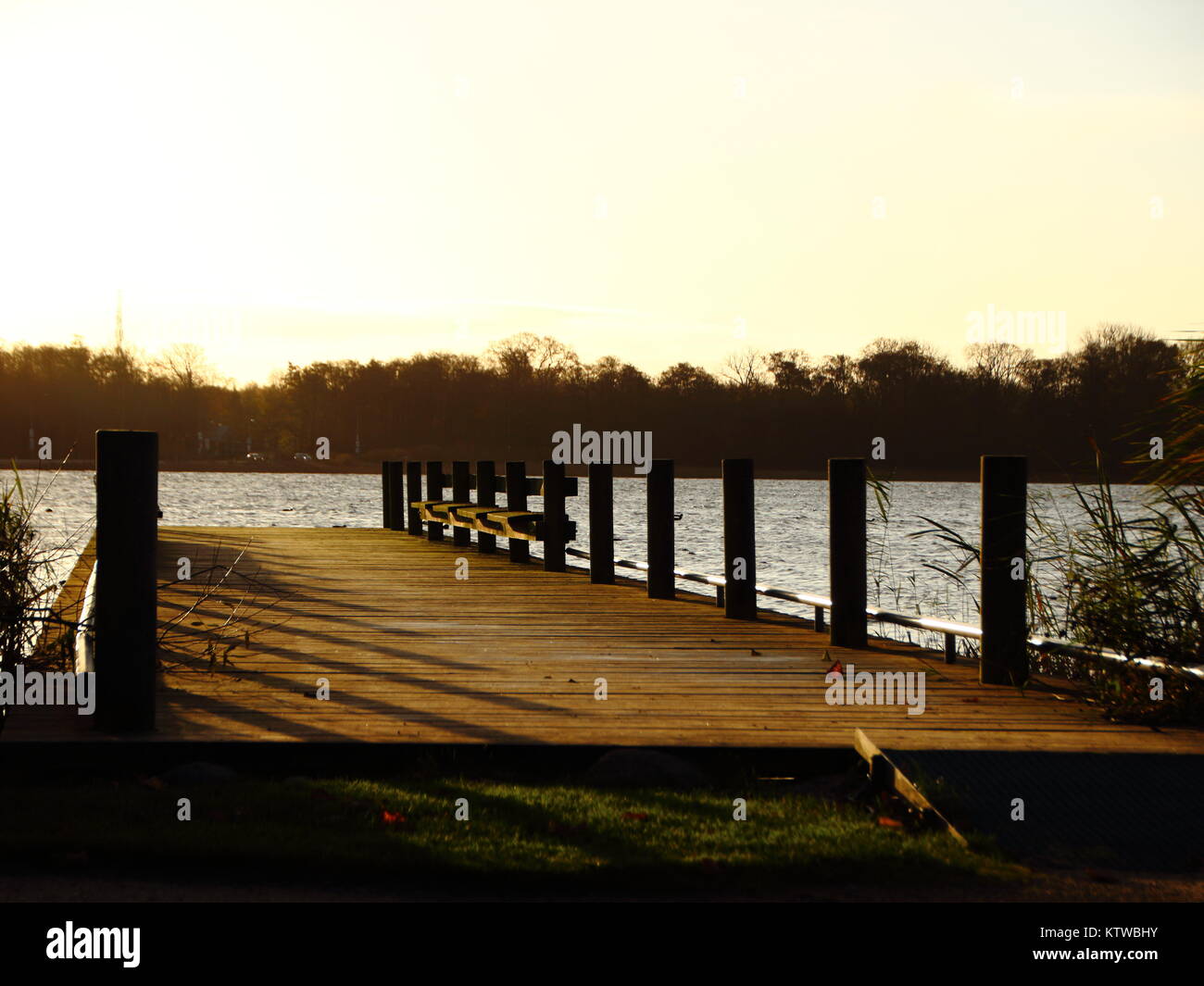 Wooden Pier at Lake in Morning Light Stock Photo - Alamy