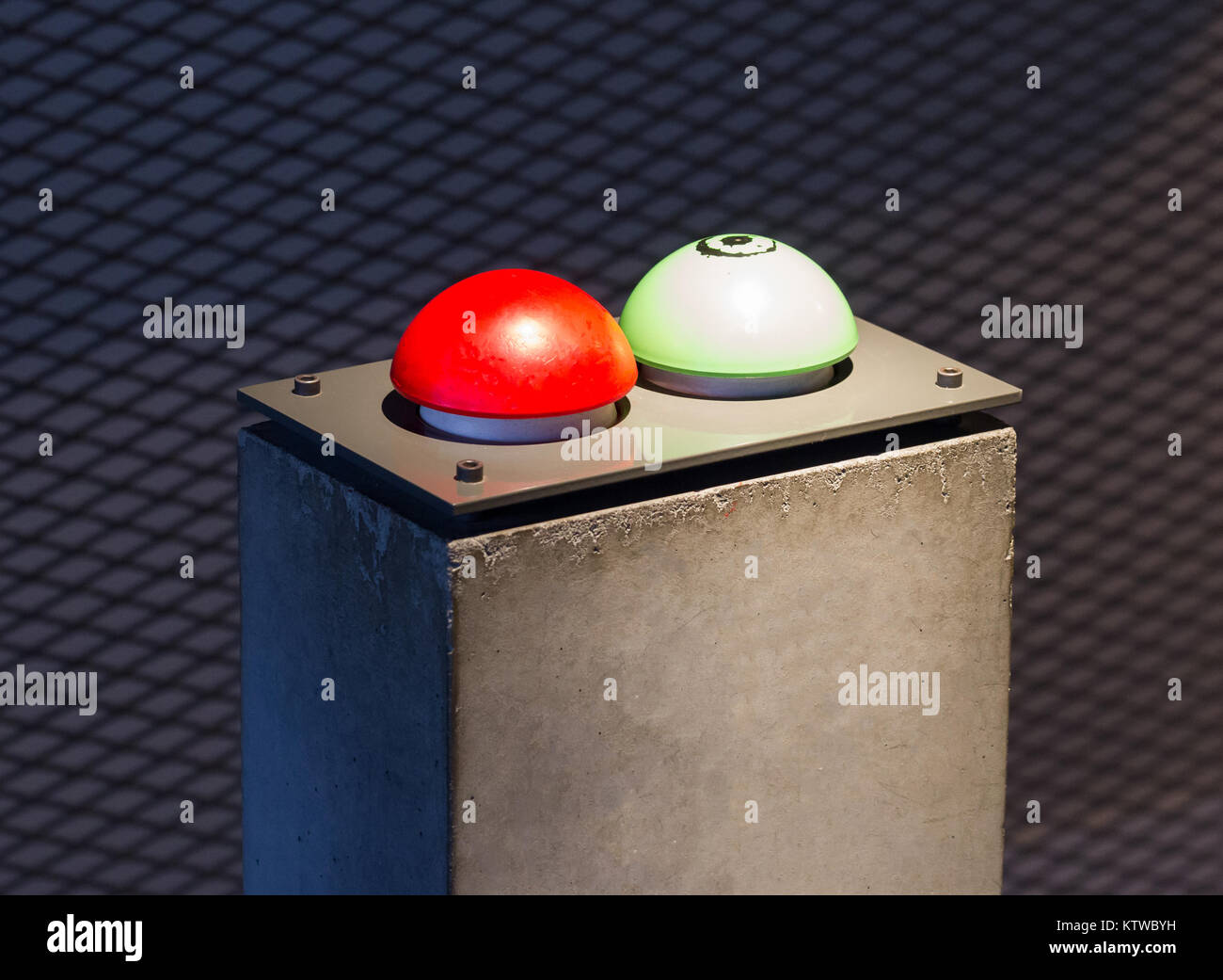 Red and green button on a concrete pillar Stock Photo - Alamy