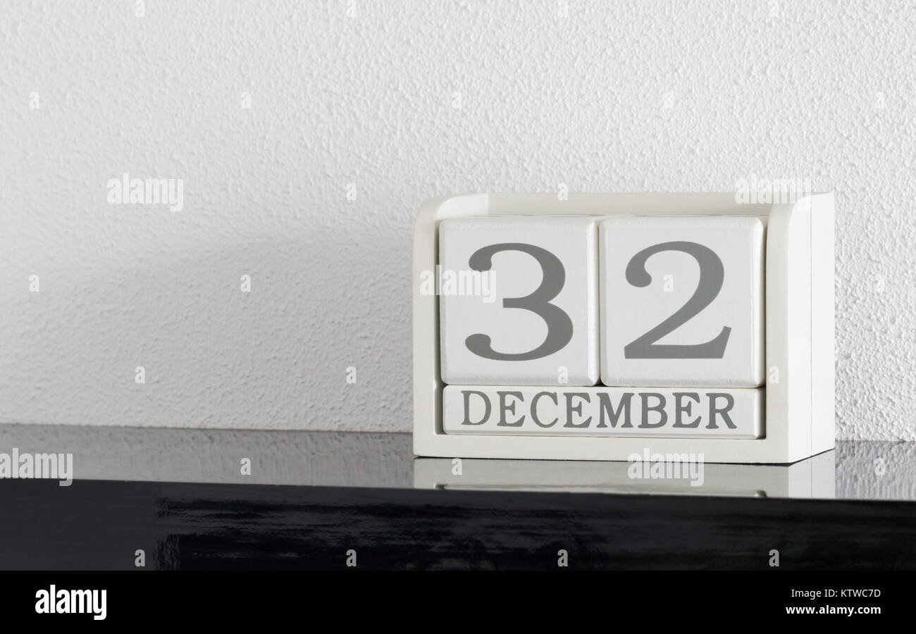 White block calendar present date 32 and month December on white wall ...