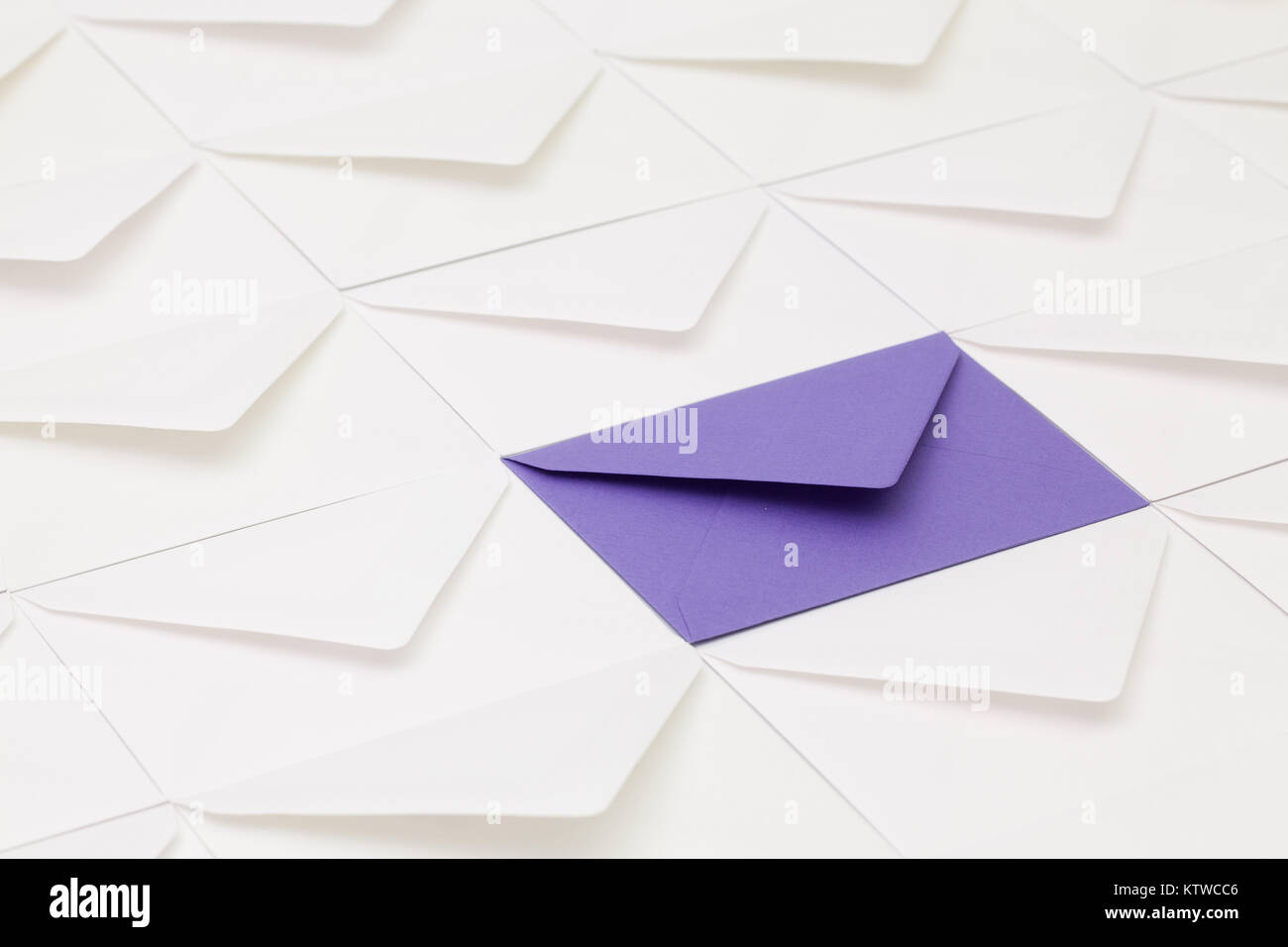 Composition with white envelopes and one purple envelope on the table ...