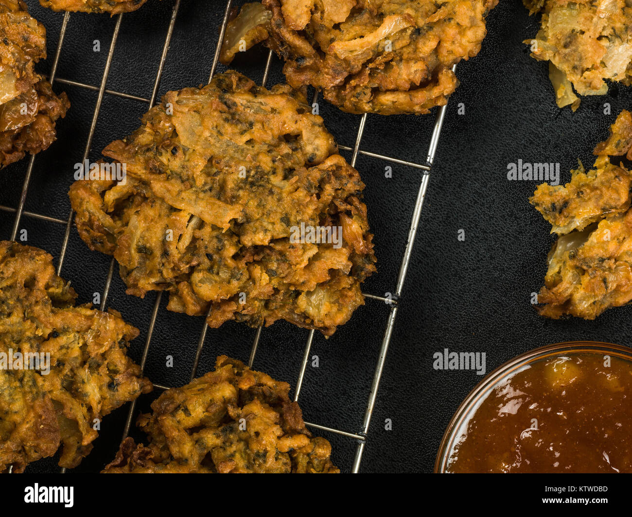 Onion Bhajis With Mango Chutney Against a Black Background Stock Photo ...
