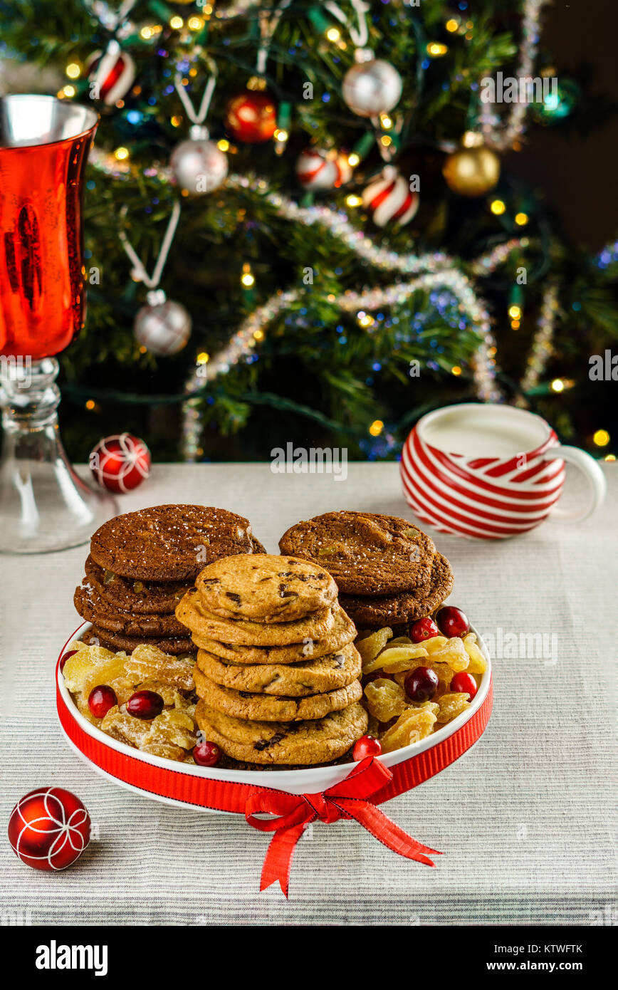 freshly baked chocolate chip cookies on a table with blurred background ...