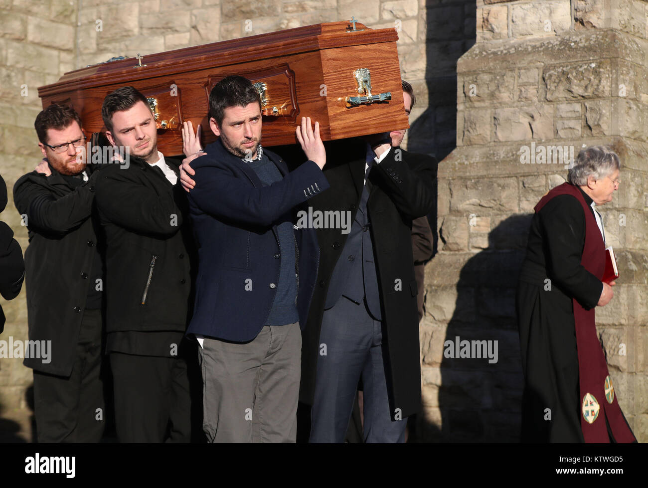 Rev Harold Good walks in front of Dr Maurice Hayes coffin as its ...