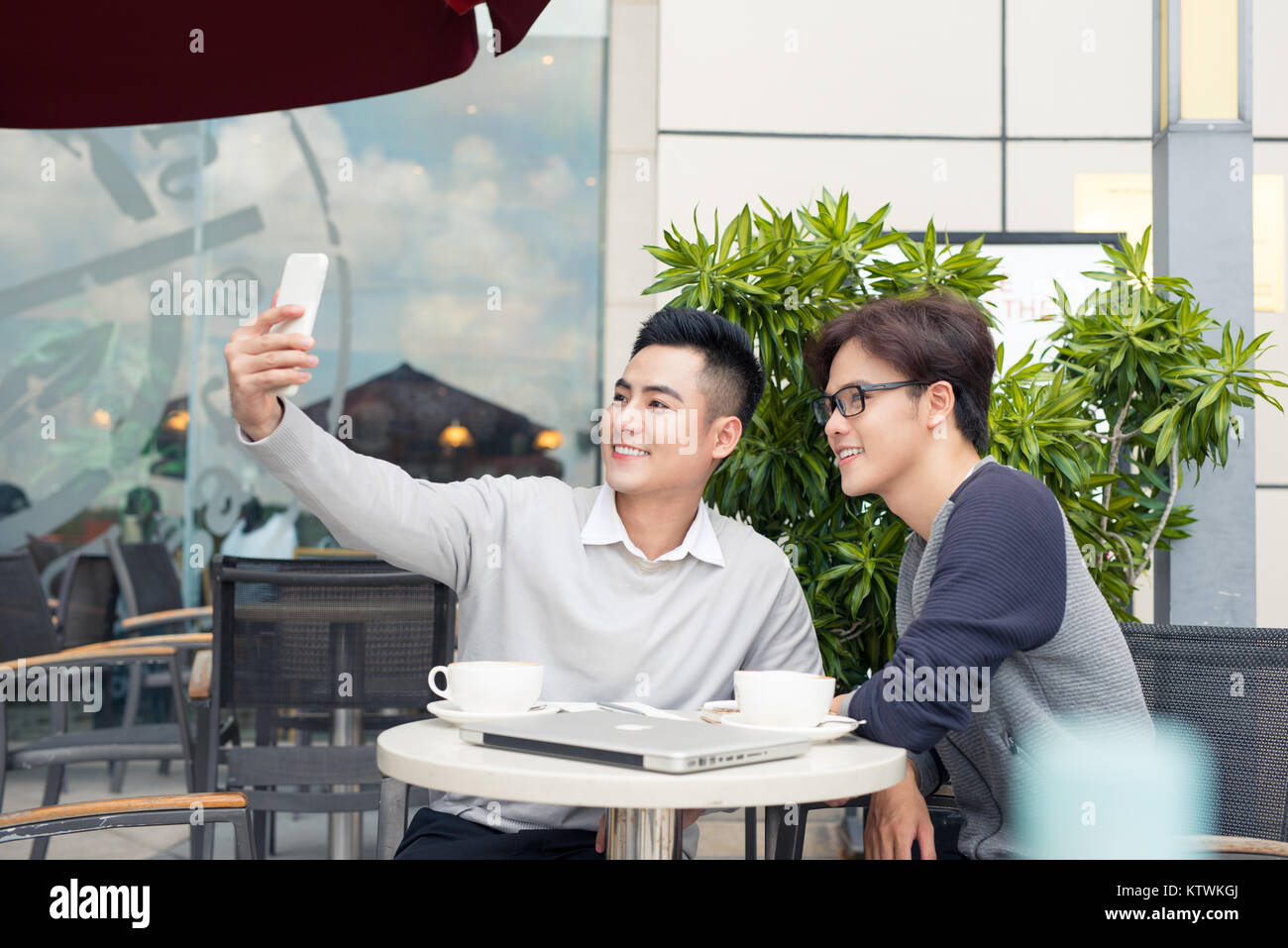 Two men are taking a selfie with a cellphone Stock Photo - Alamy