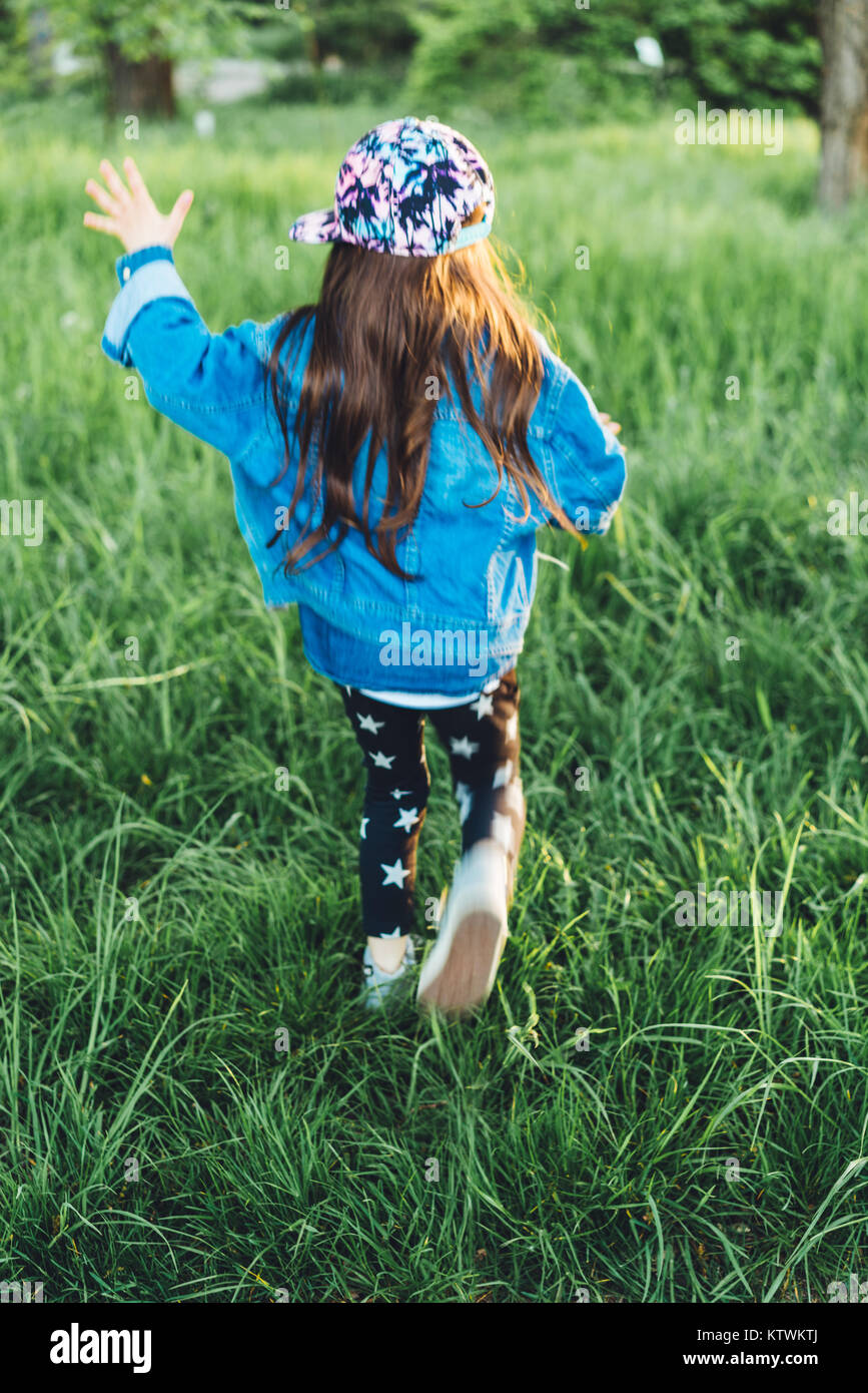 little, beautiful girl on the lawn Stock Photo - Alamy