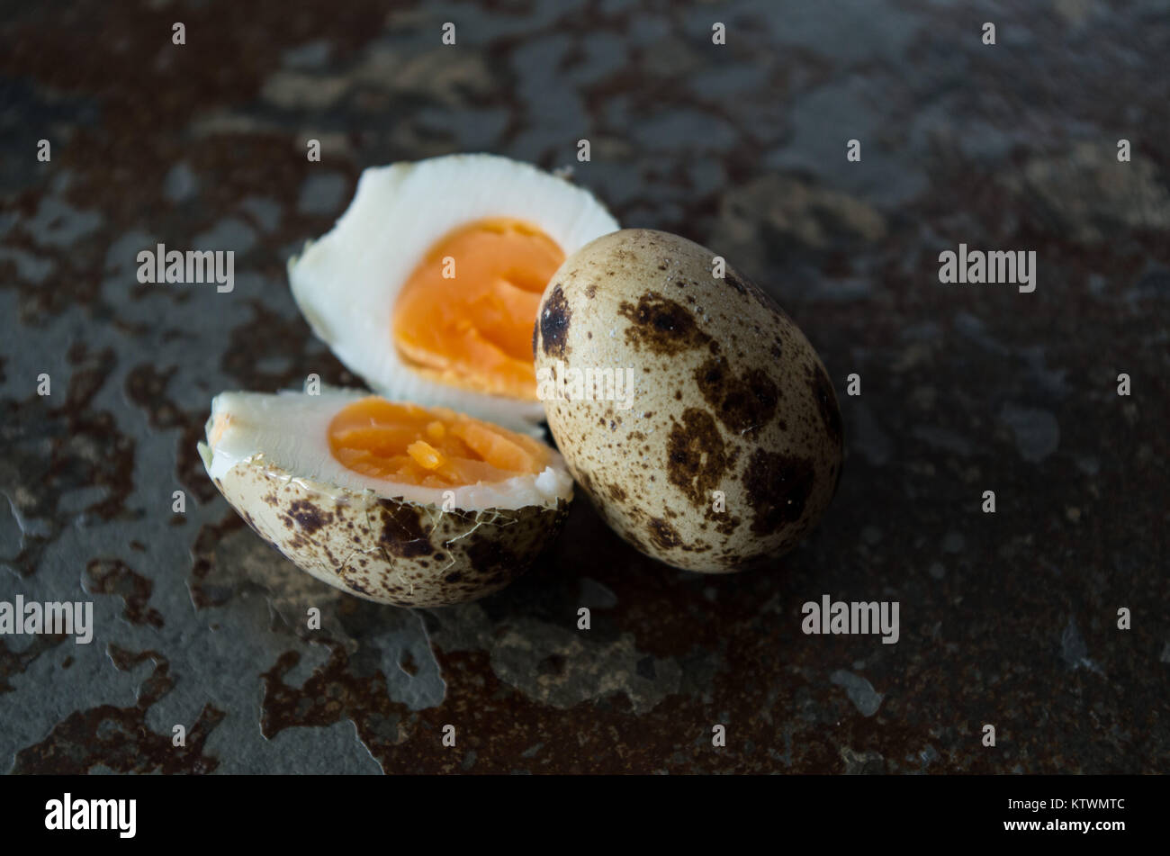 One quail egg open one still closed Stock Photo - Alamy