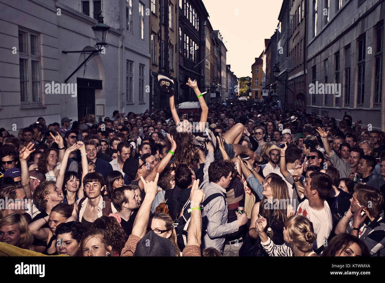 A young woman is crowd surfing at the annual street og block party ...