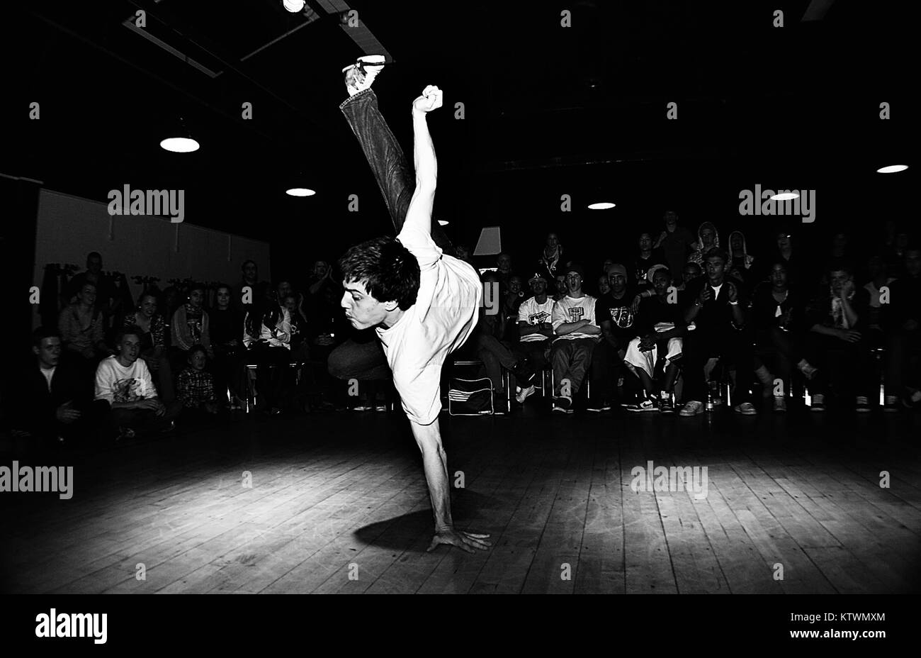 A b-boy is making his tricks in this round on the floor of a breakdance ...