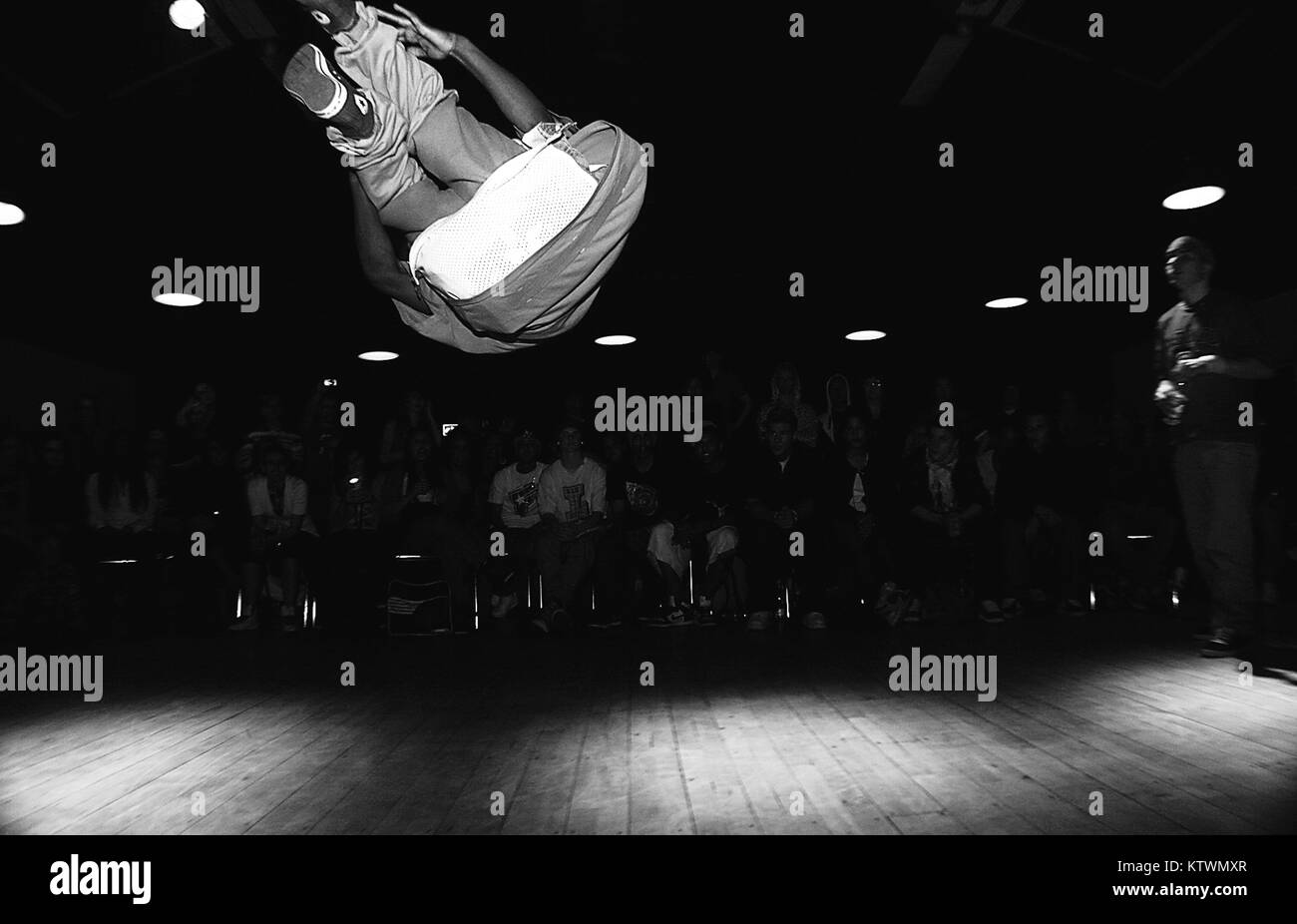 A b-boy is making his tricks in this round on the floor of a breakdance ...