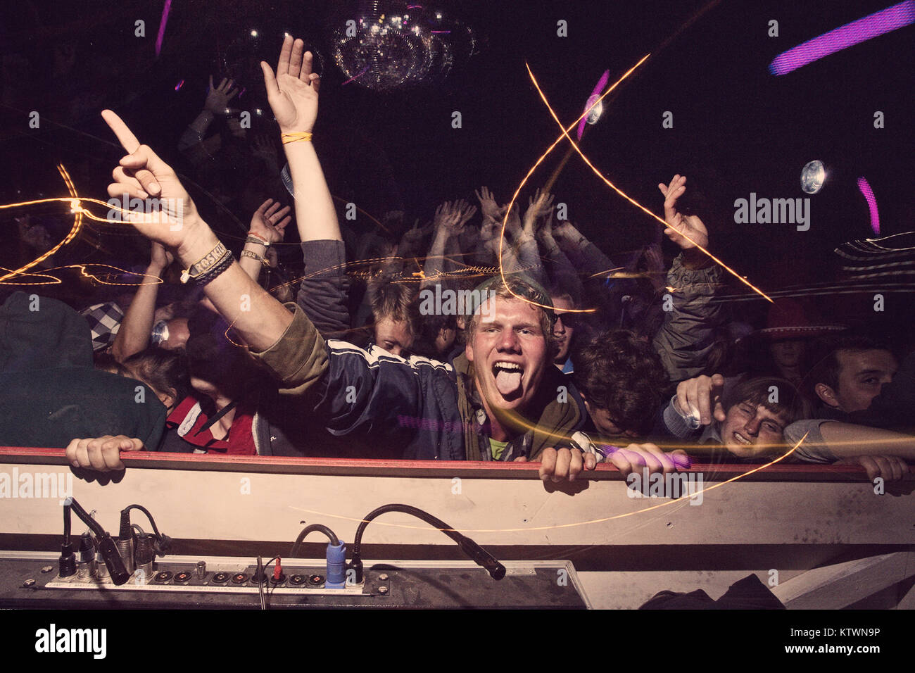 A crowd of party people is attending a rave party at Roskilde Festival ...