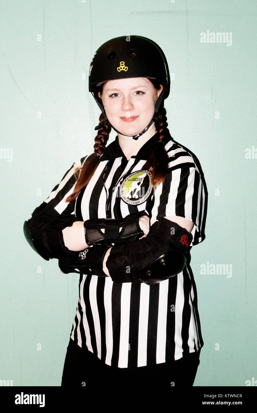 A Roller Derby referee in her striped shirt. Roller Derby is a contact ...