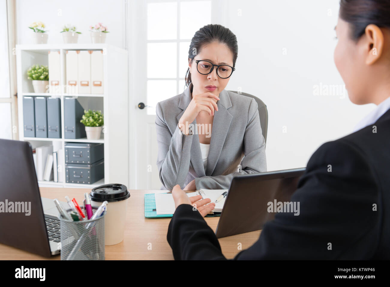 young company woman boss looking at document feeling confused when her ...