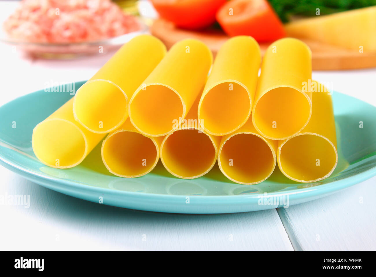 Italian pasta cannelloni. Raw tube for stuffing stuffing surrounded by ...