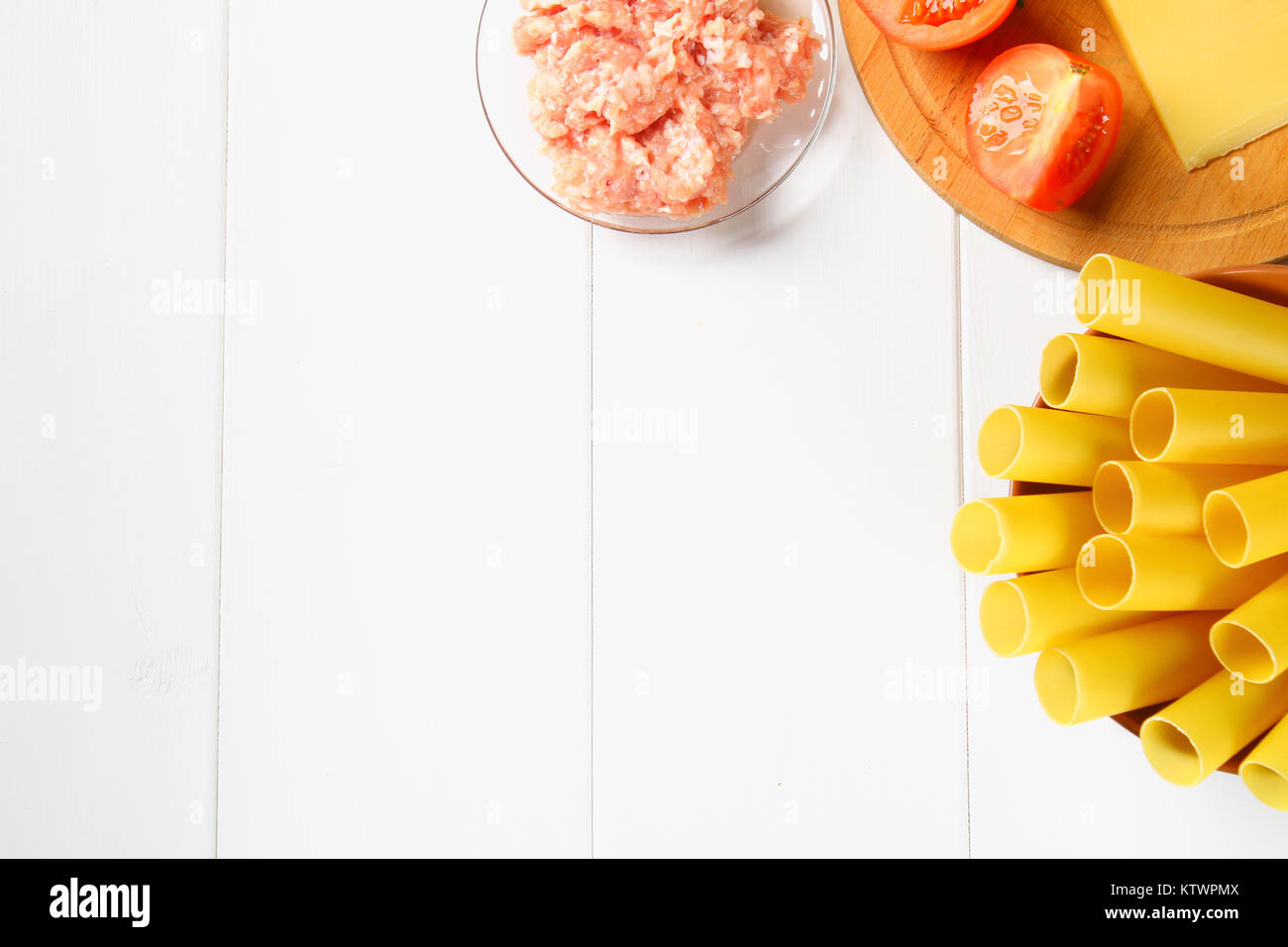 Italian pasta cannelloni. Raw tube for stuffing stuffing surrounded by ...