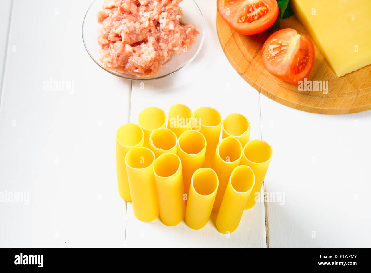 Italian pasta cannelloni. Raw tube for stuffing stuffing surrounded by ...