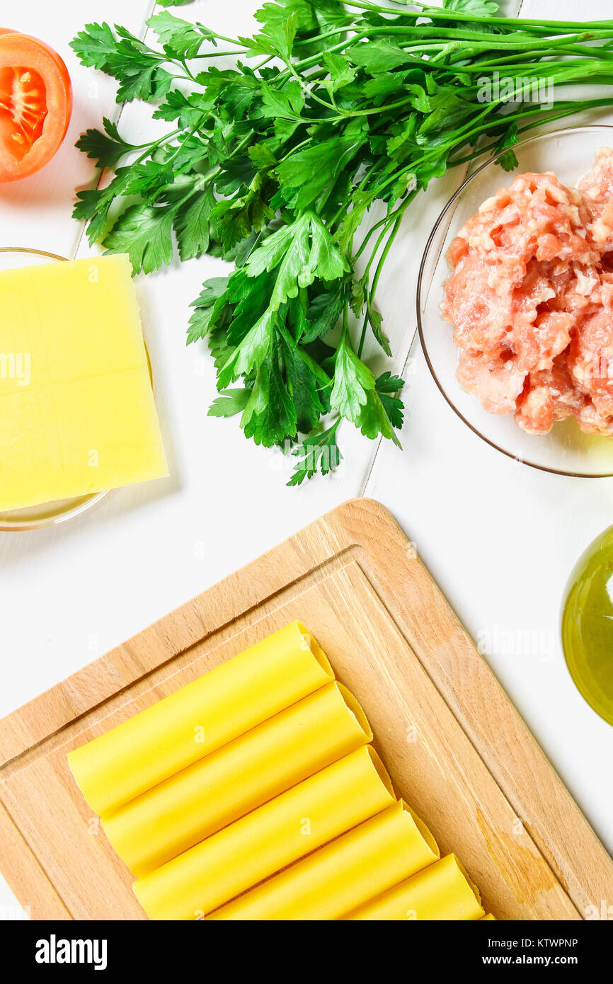 Italian pasta cannelloni. Raw tube for stuffing stuffing surrounded by ...