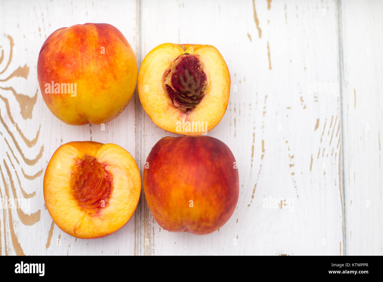 a lot of fresh peaches on a white table. Top view Stock Photo - Alamy