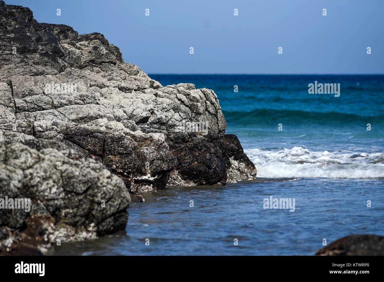Rock protruding from the sea hi-res stock photography and images - Alamy