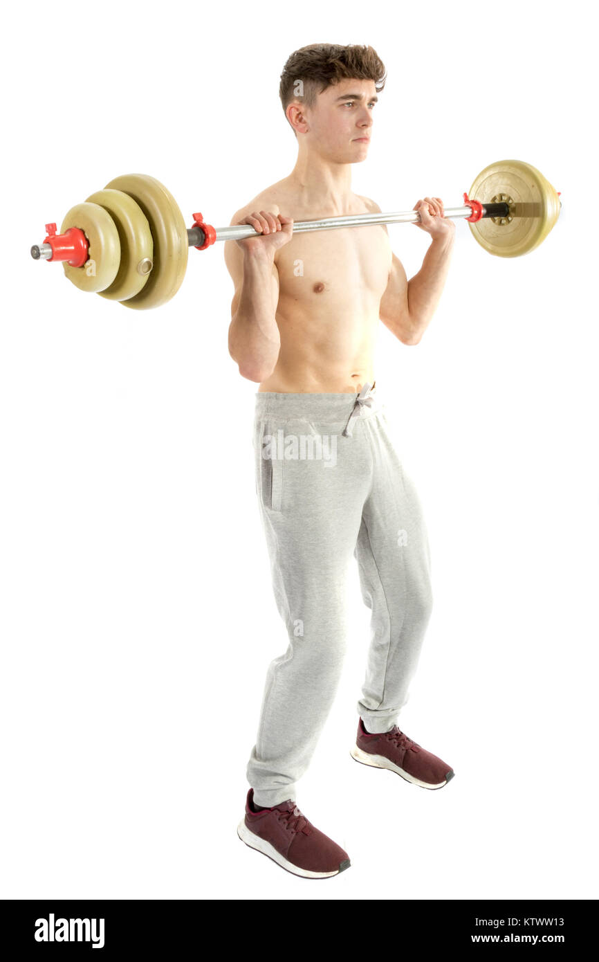 18 year old teenage boy using a barbell Stock Photo - Alamy