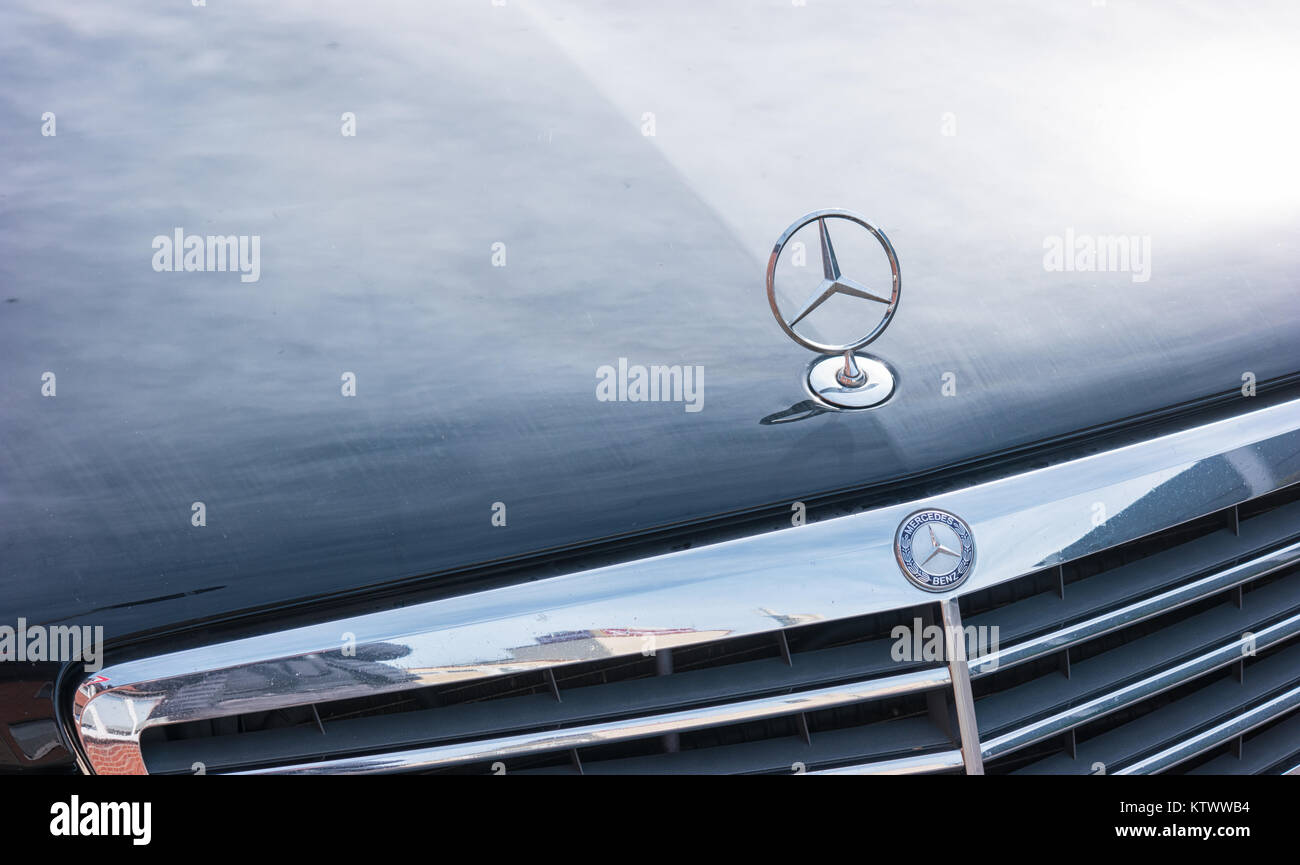 Mercedes Benz logo on a blue car. Mercedes-Benz is a German automobile ...