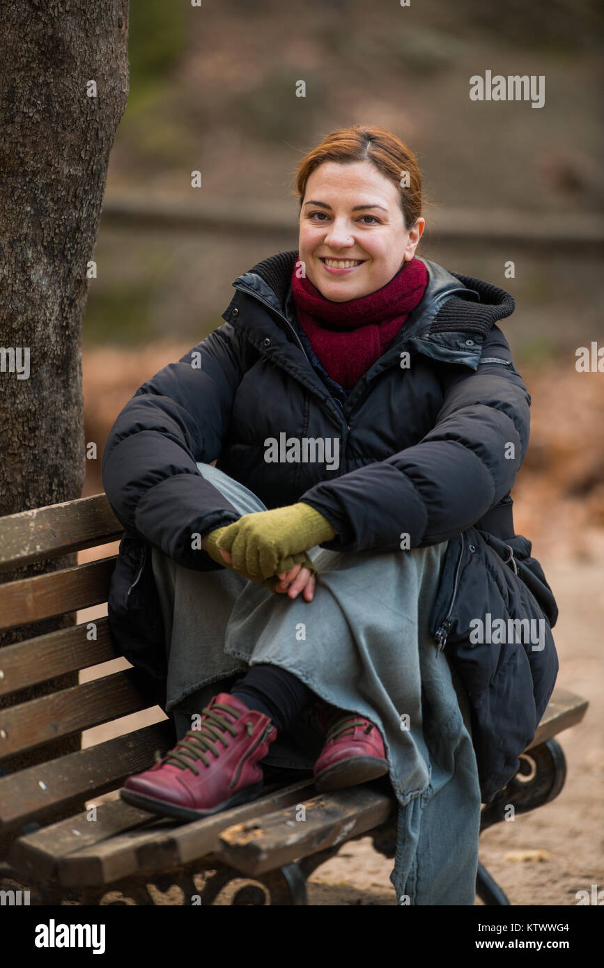 Woman sitting on Bench, Outdoor shots in Park, Winter Stock Photo - Alamy