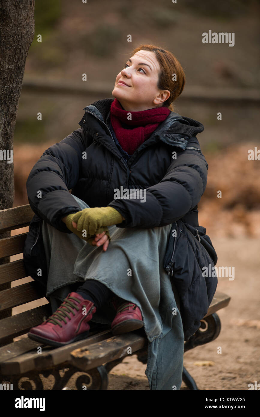 Woman sitting on Bench, Outdoor shots in Park, Winter Stock Photo - Alamy