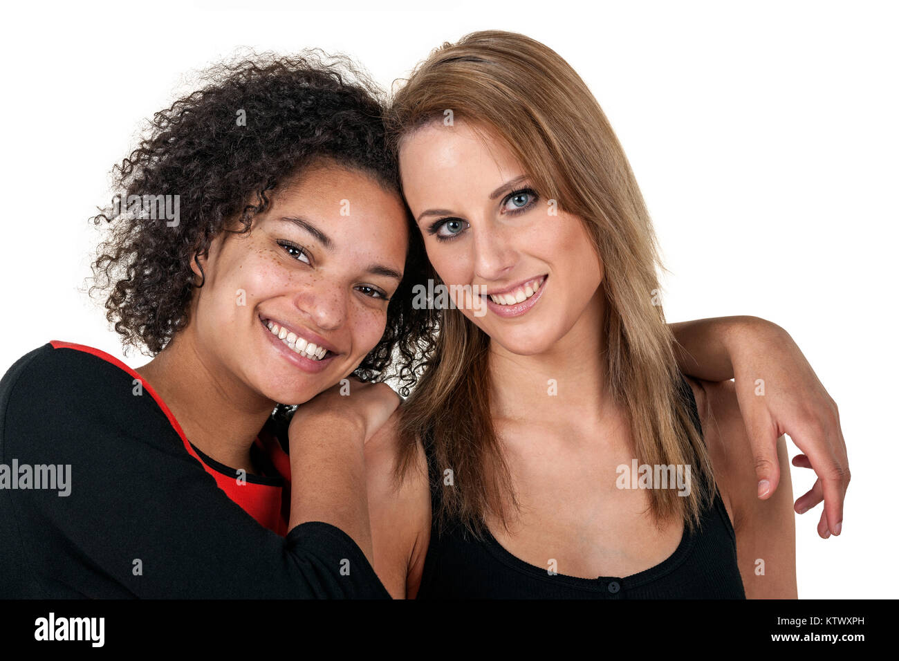 Female friends from different race smiling happily and hugging each ...