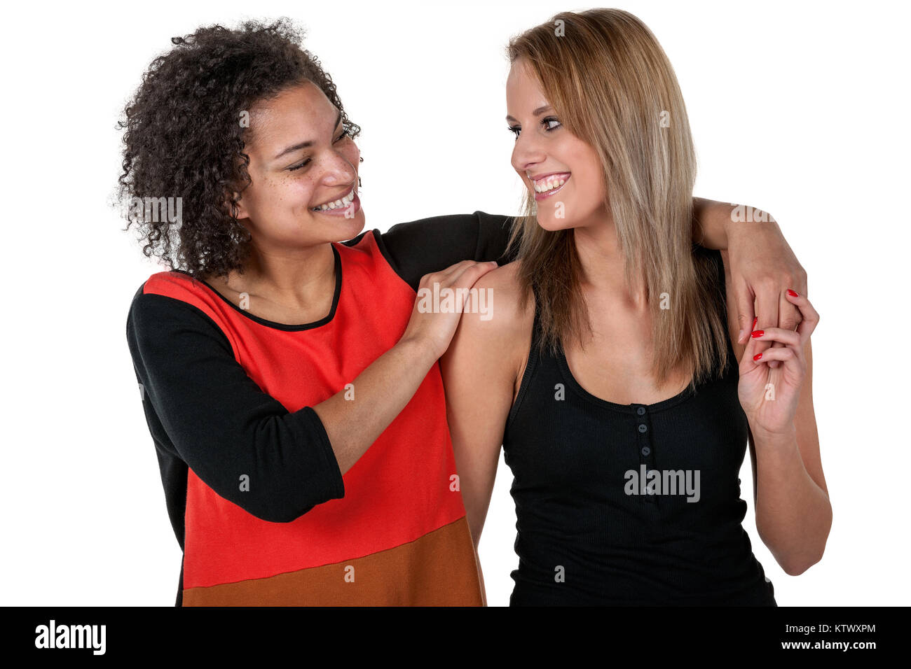 Female friends from different race smiling happily and hugging each ...