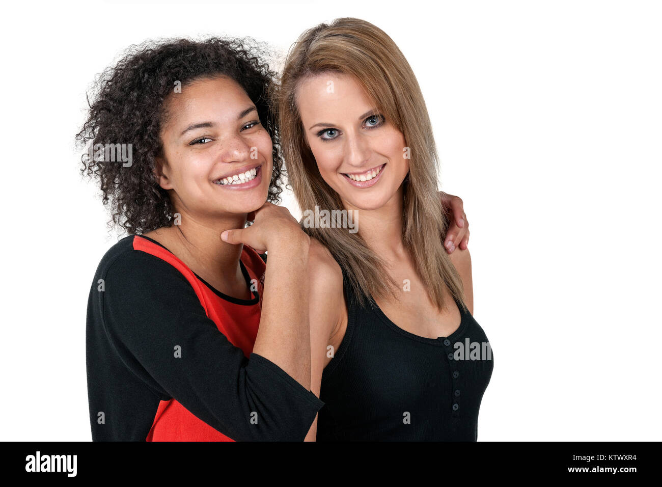 Female friends from different race smiling happily and hugging each ...