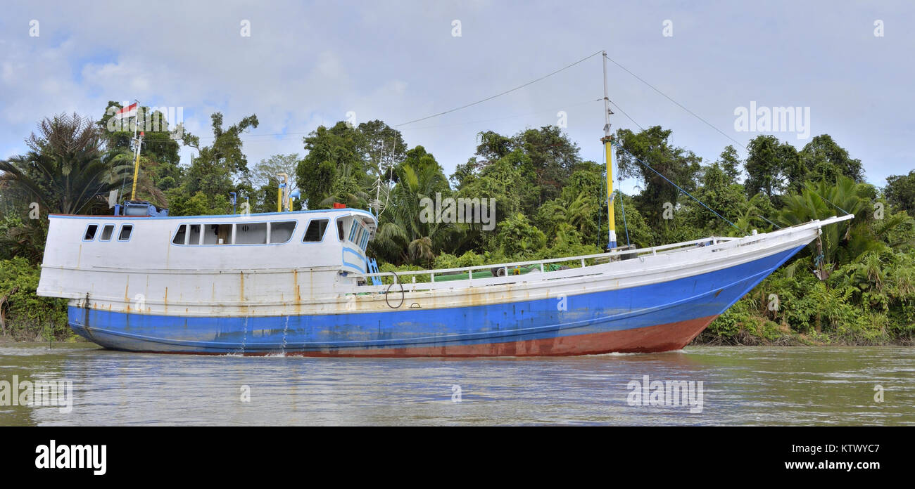 Indonesian traditional merchant ship on the river. New Guinea Island ...