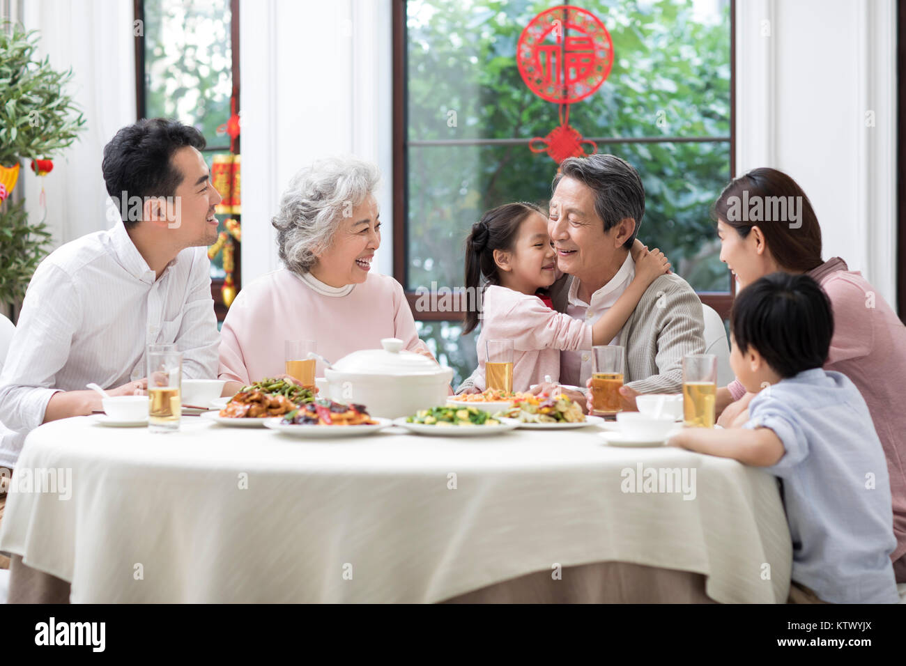 Happy family having Chinese New Year dinner Stock Photo - Alamy