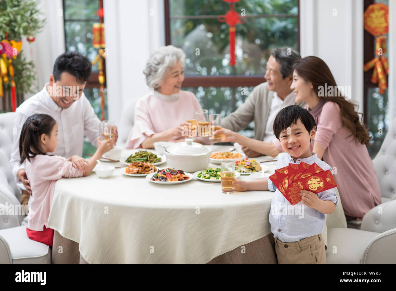 Happy family having dinner red hi-res stock photography and images - Alamy