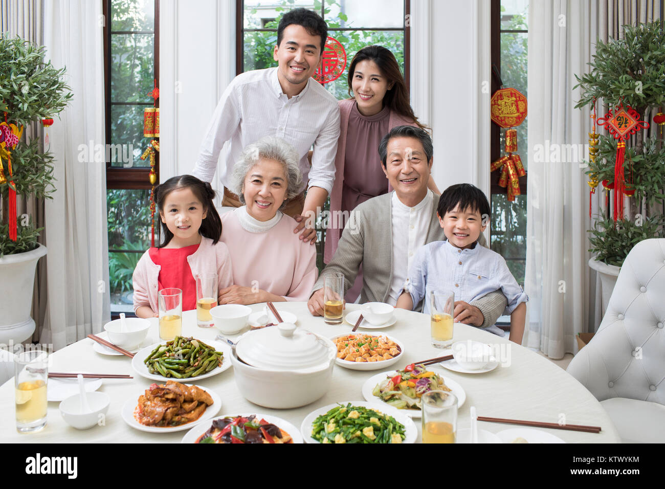 Happy family having dinner red hi-res stock photography and images - Alamy