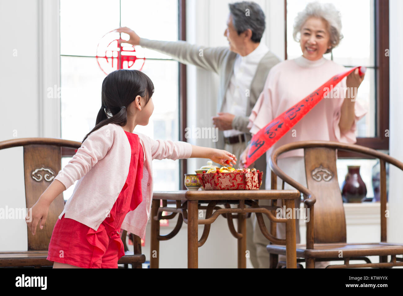 Happy family decorating their house for Chinese New Year Stock Photo ...