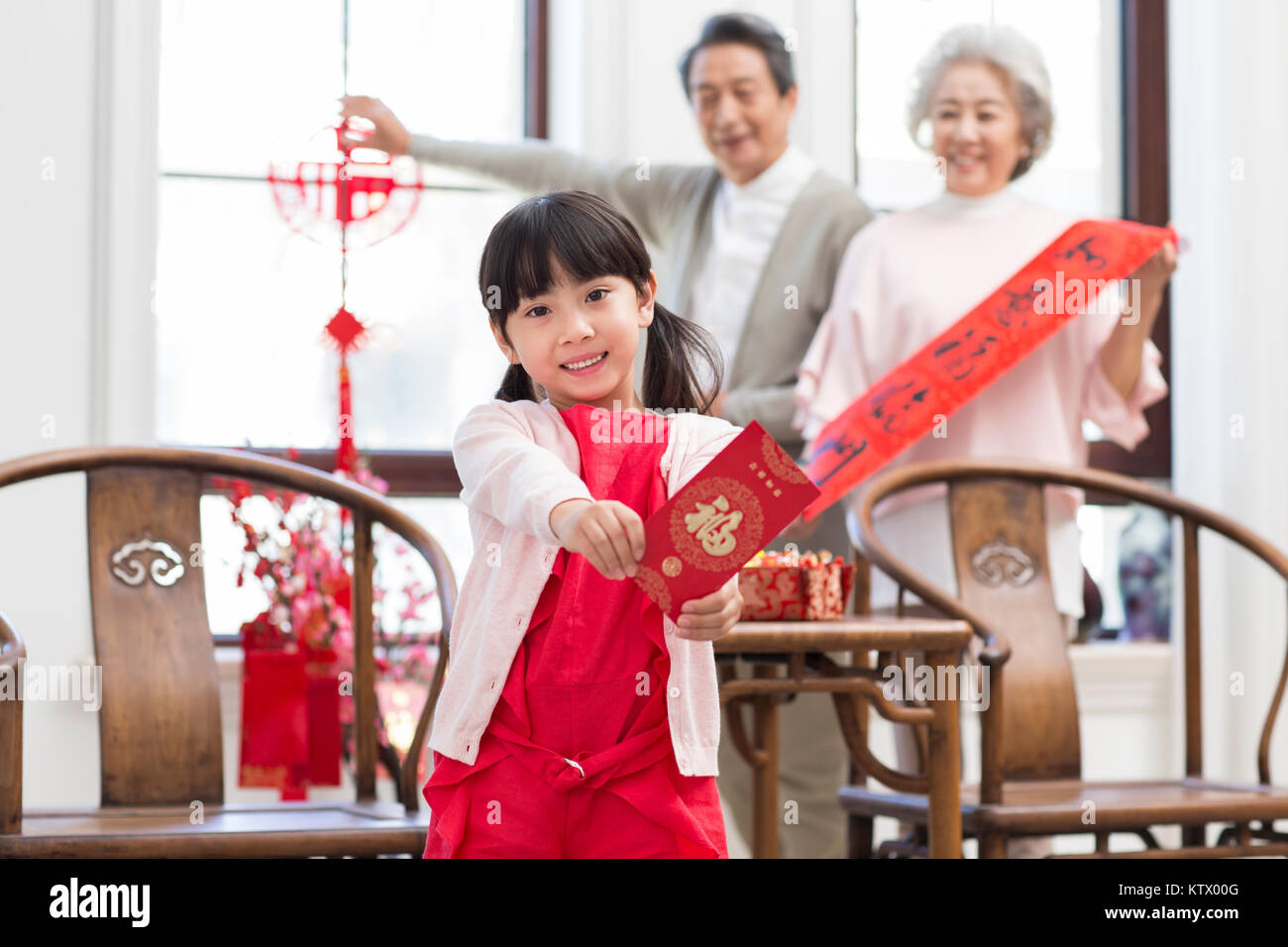 Happy little girl and grandparents celebrating Chinese New Year Stock ...