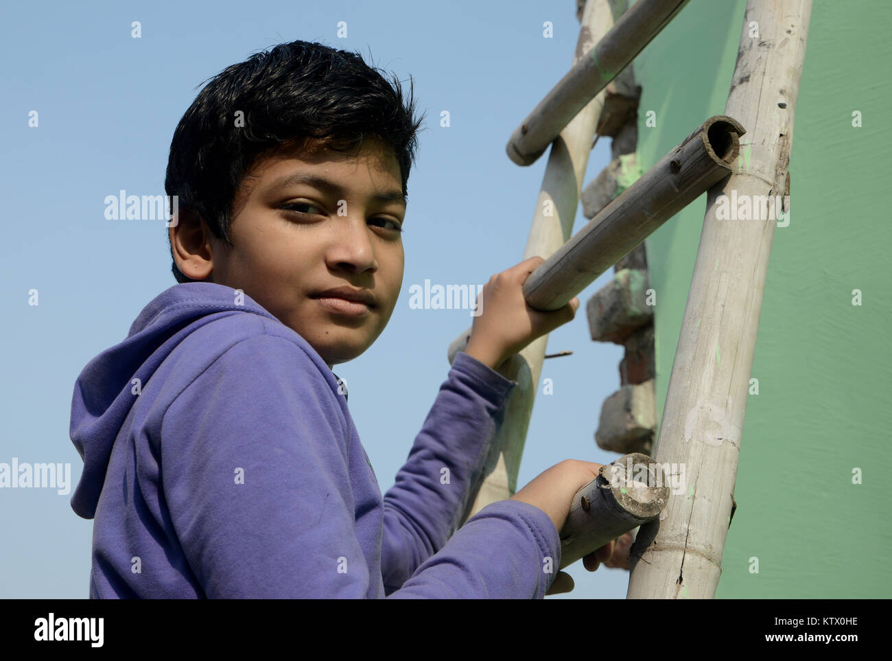 Boy climbing up ladder hi-res stock photography and images - Alamy