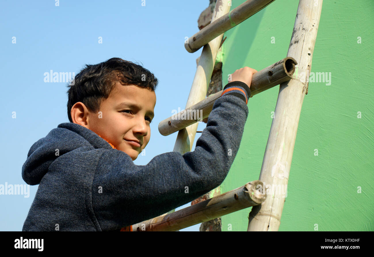 Boy Climbing a Ladder Stock Photo - Alamy
