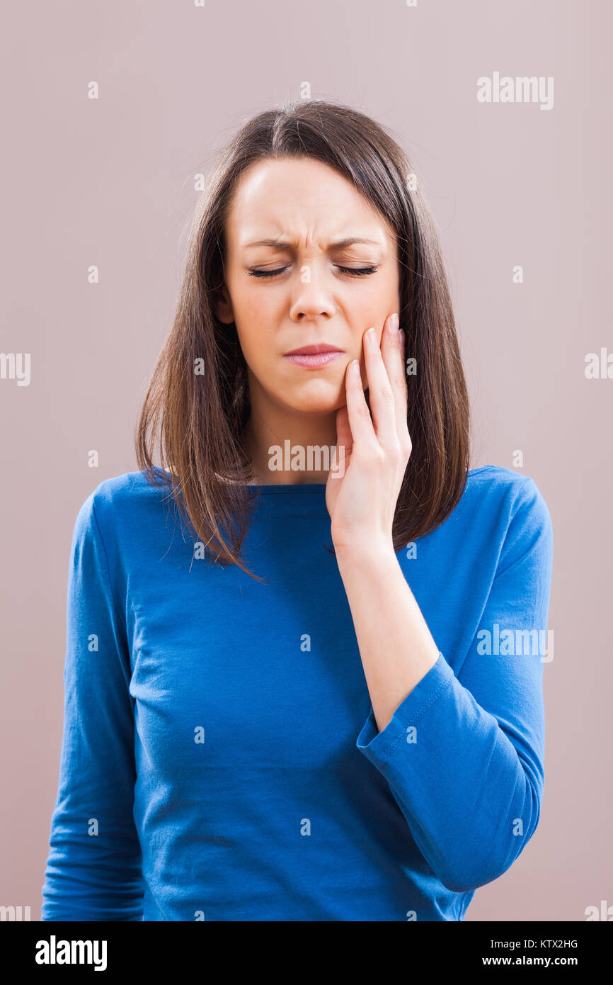 Portrait of young woman who is having toothache Stock Photo - Alamy