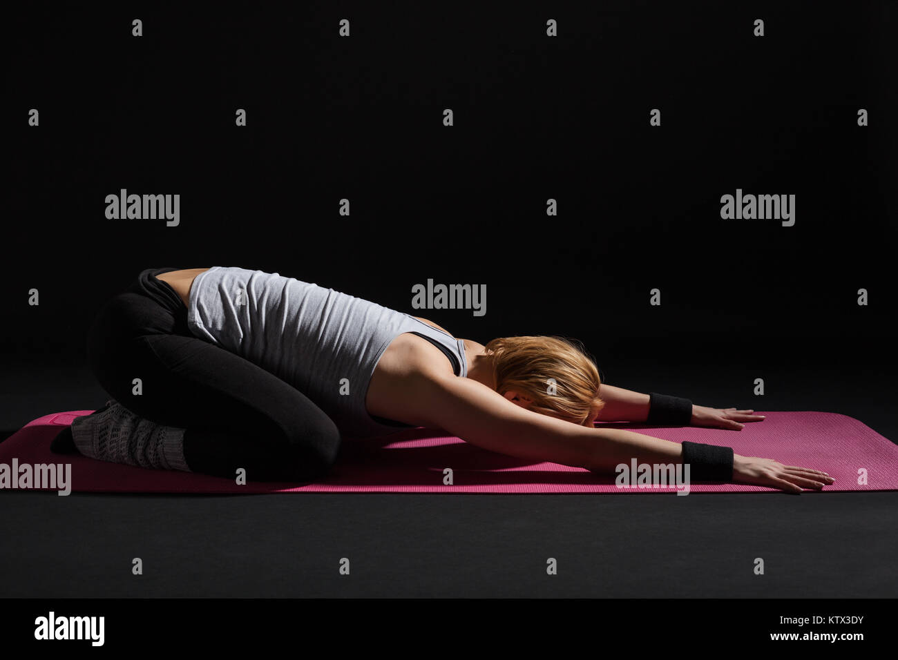 Young woman practicing yoga, Shashankasana / Hare pose Stock Photo - Alamy