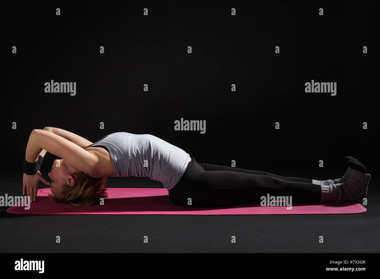 Young woman practicing yoga, Matsyasana / Fish pose Stock Photo - Alamy