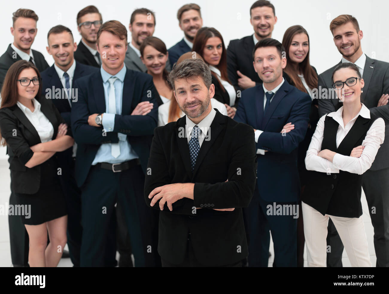 confident businessman standing on background of her business team Stock ...