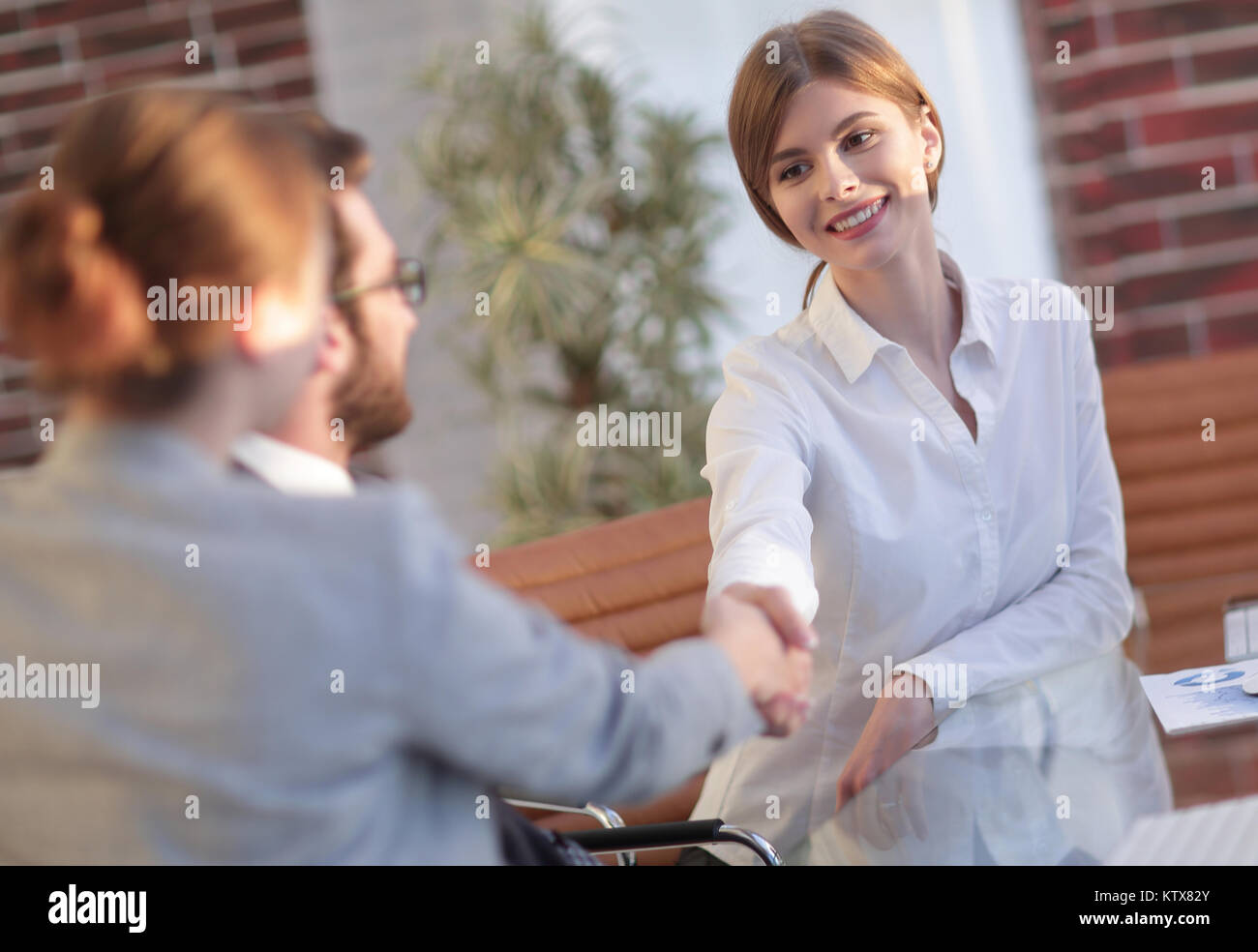 business woman greets the employee with a handshake Stock Photo - Alamy