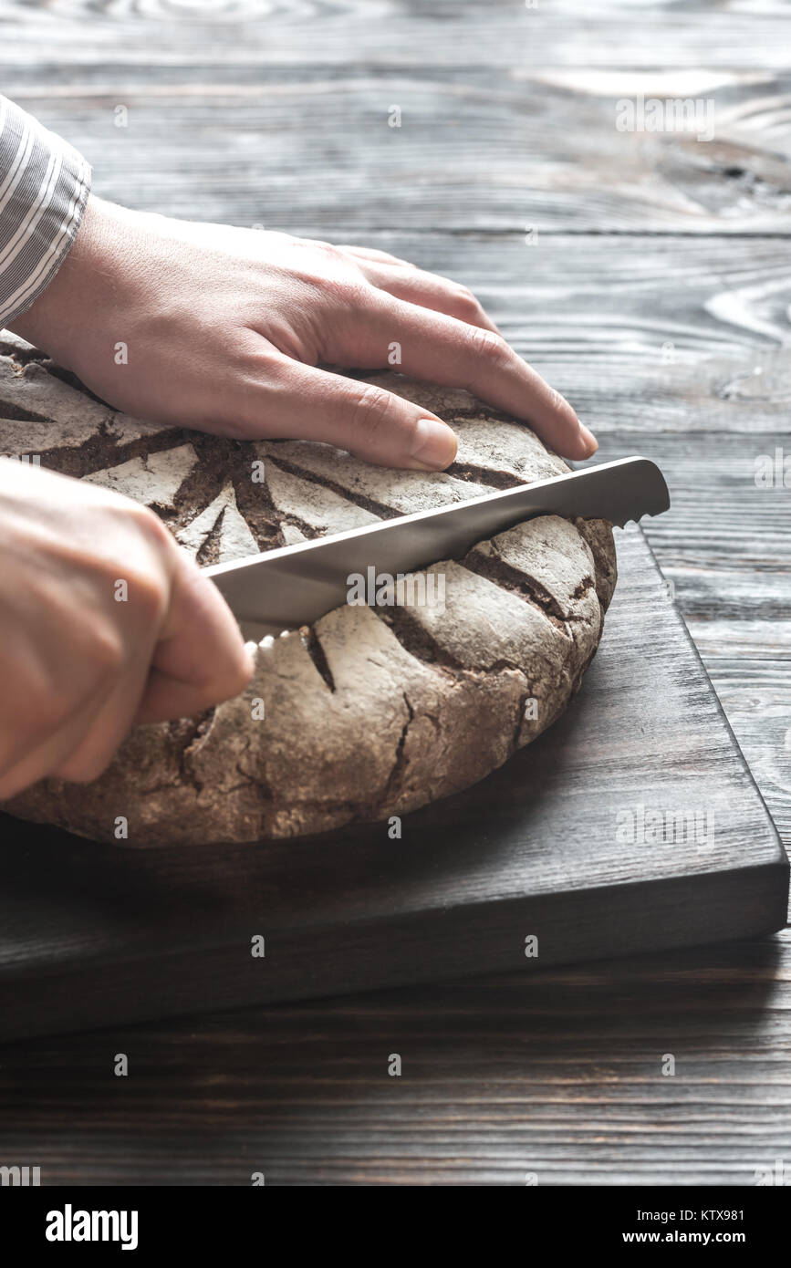 Male hands cutting loaf hi-res stock photography and images - Alamy