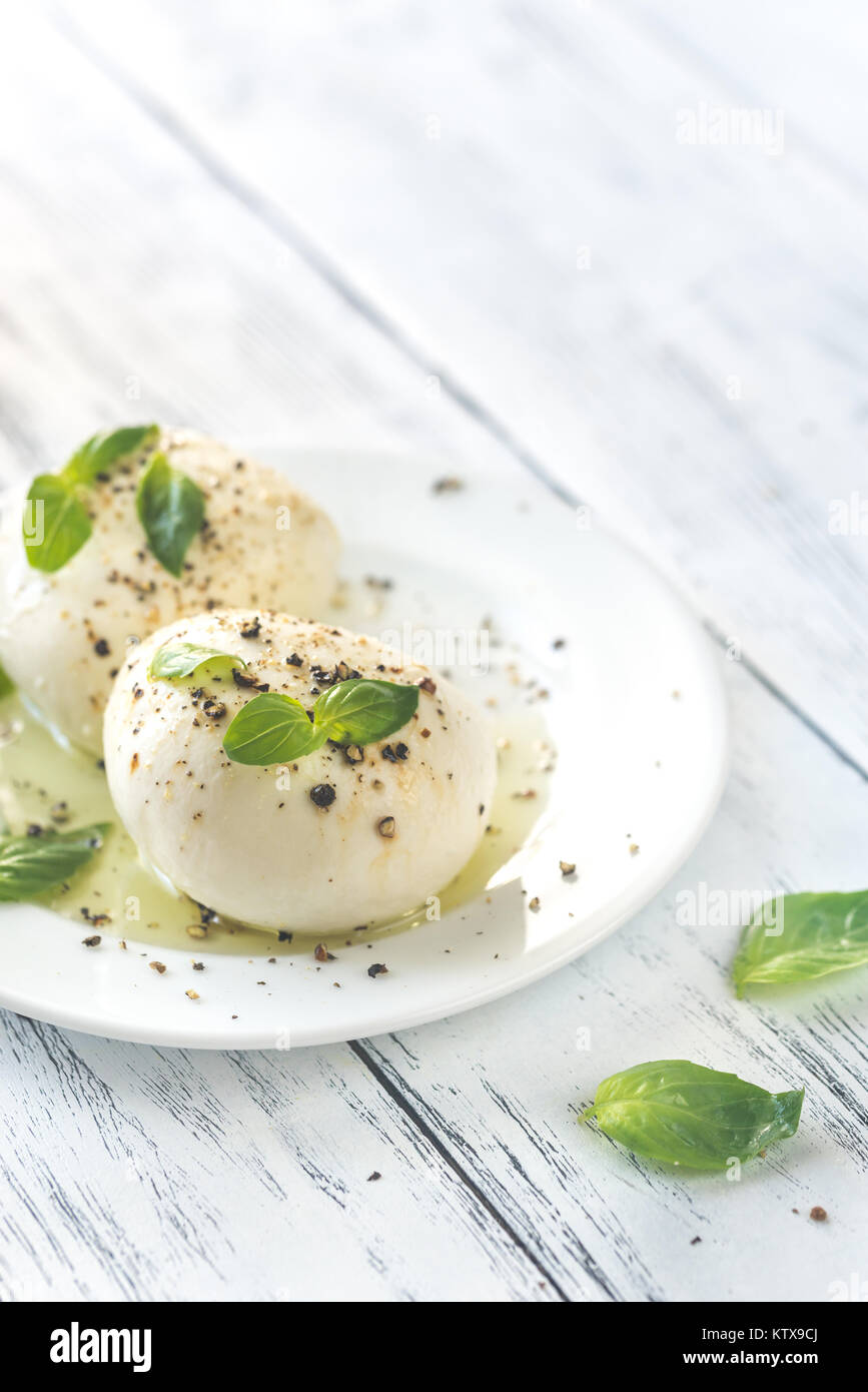 Mozzarella with fresh basil leaves Stock Photo - Alamy