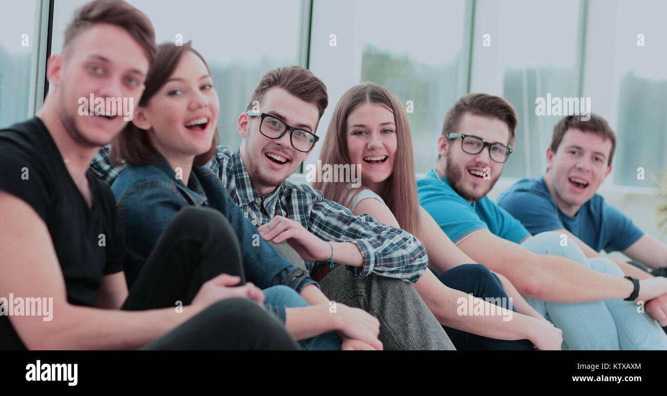 University a group of students sitting on the floor in the gym a Stock ...